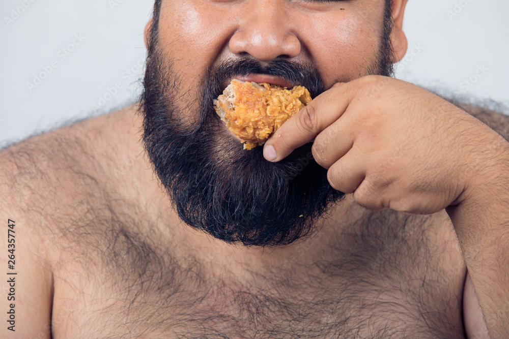 Fat men eating deep fried chicken,Fat man eating fried chicken isolated ...