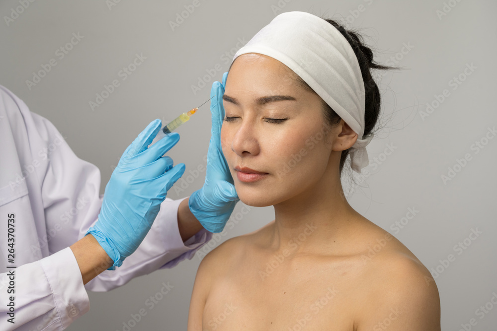 Treatment with botox concept, Asian Woman receiving Botox injection ...
