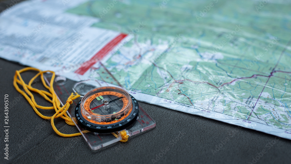 The magnetic compass is located on a topographic map. Satellites ...