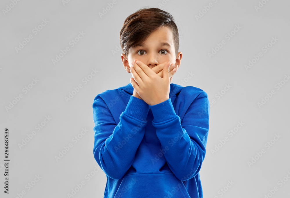 childhood, expressions and people concept - shocked little boy in blue ...