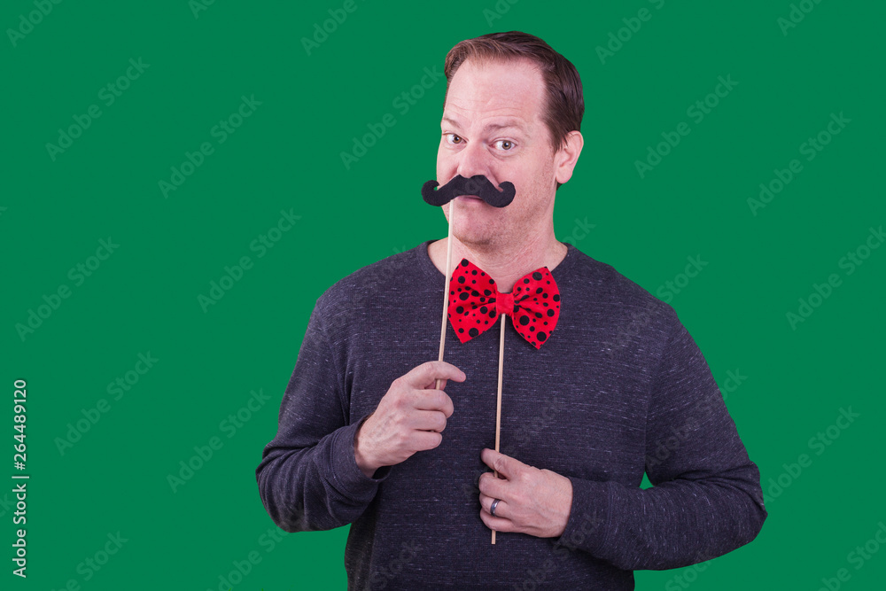 Adult red haired man holding fake mustache and bowtie photo booth prop ...