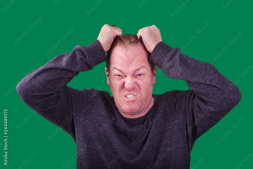 Red headed middle aged man pulling hair angry facial expression on ...