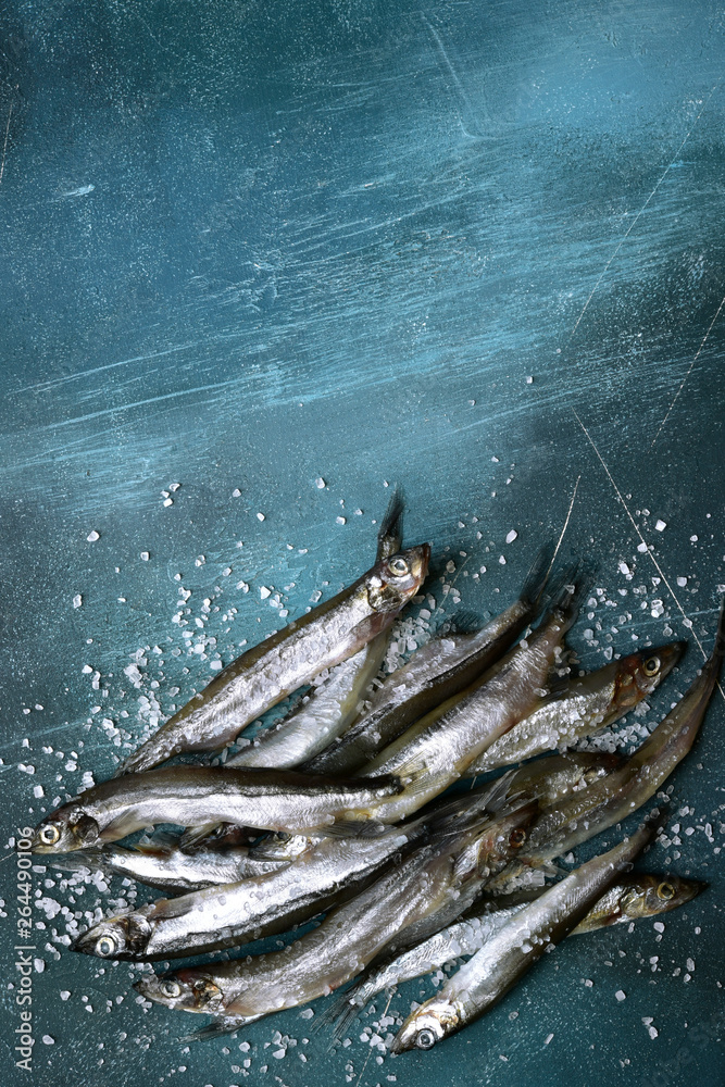 Raw capelin fish with salt.Top view with copy space. Stock Photo ...