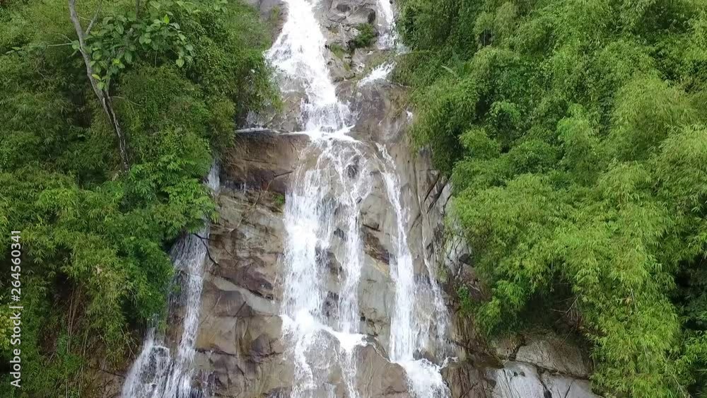 Pull out shot from drone revealing a beautiful view of a waterfall ...