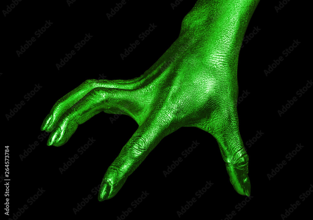 Green witch's hand is isolated on a black background. Hand gesture ...