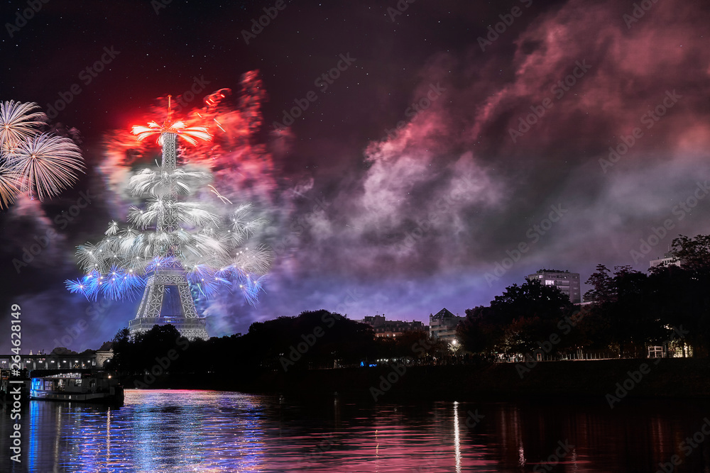 Fireworks show on the eiffel tower displaying the French national flag ...