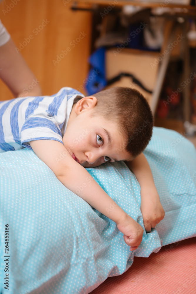little kid with cerebral palsy has musculoskeletal therapy by doing ...