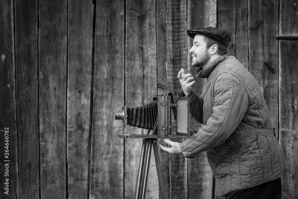 Old fashioned photographer asks for a smile. Works on large format ...