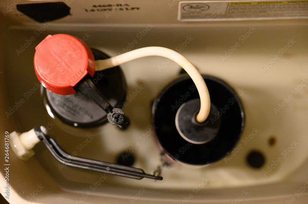 Inside water tank of toilet with float raised Stock Photo | Adobe Stock