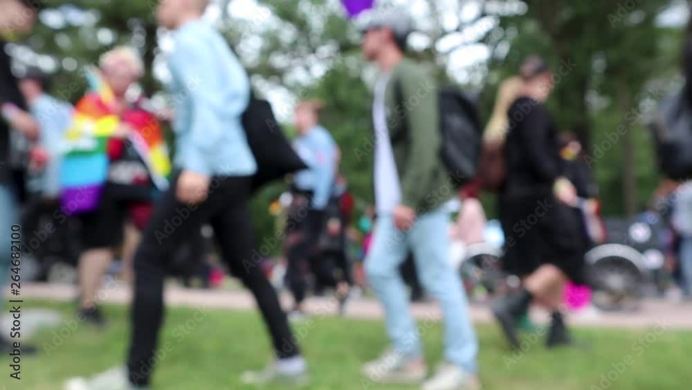 Defocused footage of a crowd at the park during LGBT pride parade ...