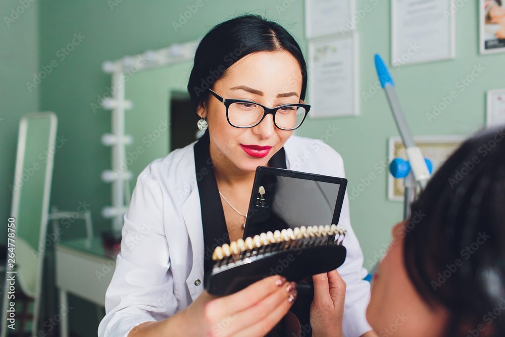 Doctor dentist explain the implant of teeth to patient in dental clinic ...