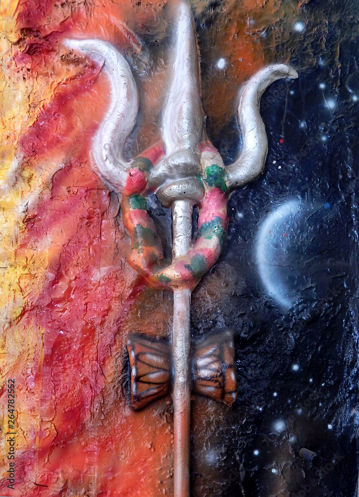 Hindu God Shiva weapon trisula or trident wall art in a temple Stock ...