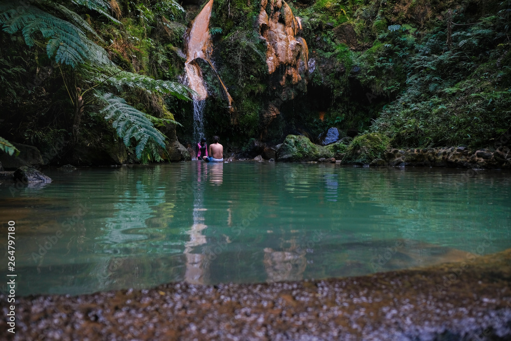 People taking bath in Caldeira Velha waterfall, Hot Springs in Azores ...