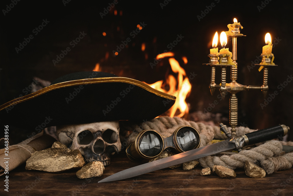 Pirate table with treasure gold, sword, binoculars, human skull ...