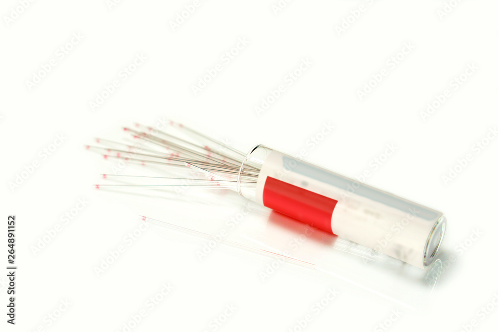 Fotka „Medical capillary glass tube emerged from container on white ...