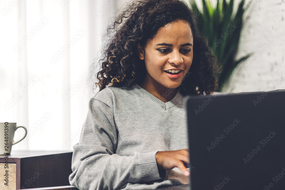 Young african american black woman relaxing and using laptop computer ...