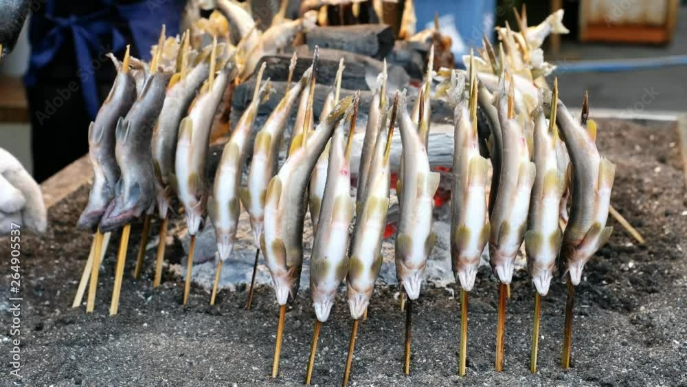 Fish Ayu with salt being charcoal broiled in Japanese grilled fish ...