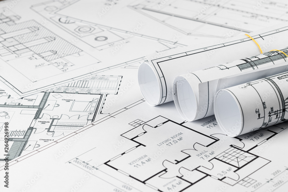 Architectural construction drawings twisted into a roll, construction ...