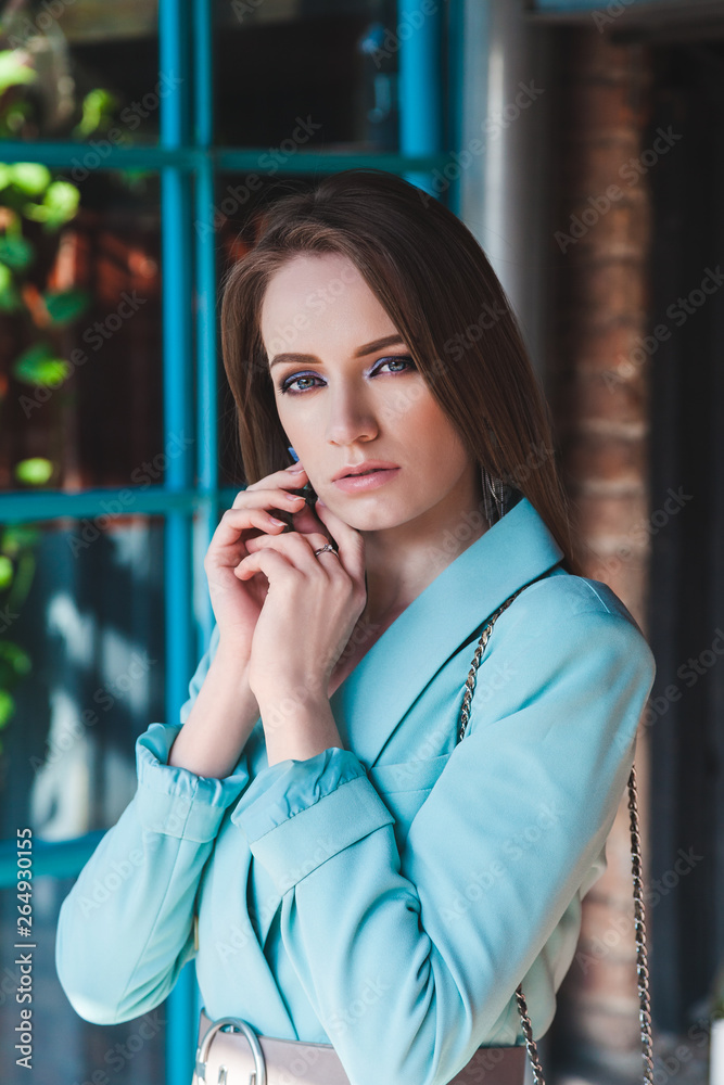 young attractive girl looking at the camera and touching her cheek ...