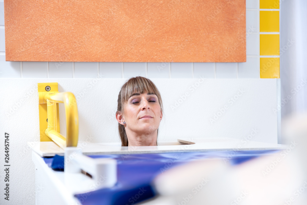 Man, a woman in her mid thirties enjoys a water / bath or physical ...