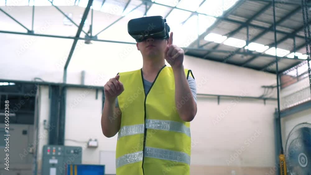 Industrial factory and manfacturing engieering worker wearing VR goggle ...