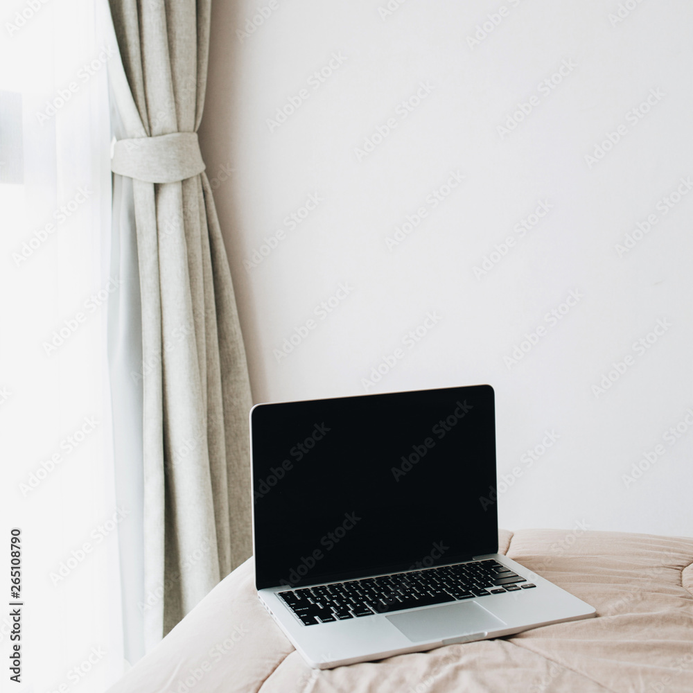 Laptop on bed. Minimal interior design concept. Freelancer business at ...