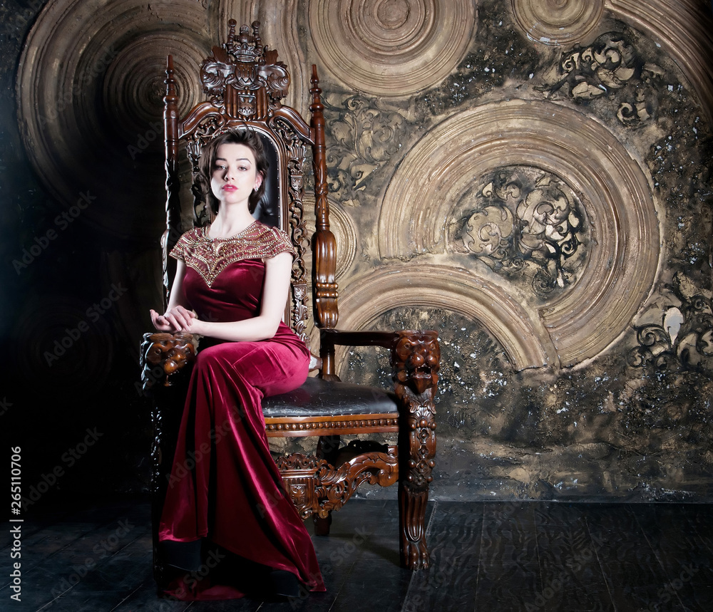 Queen in red dress sitting on throne. Symbol of power Stock Photo ...
