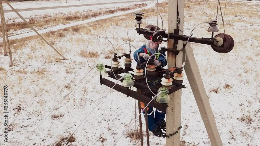 Electrician repairman working on tower at the electric station in ...