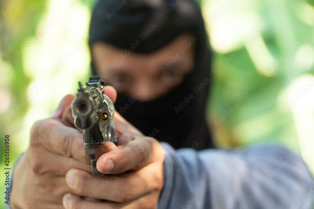 Select focus of gun. Robber in black ski mask aims with gun Stock Photo ...