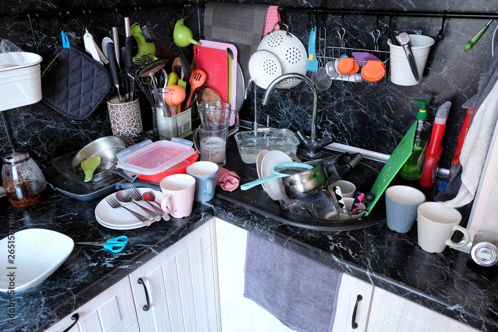 Dirty dishes in the kitchen sink and on the countertop. Not done ...