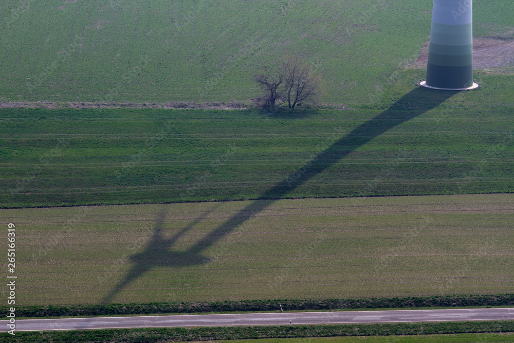 Shadow of a wind turbine on agricultural structure seen from a bird's ...