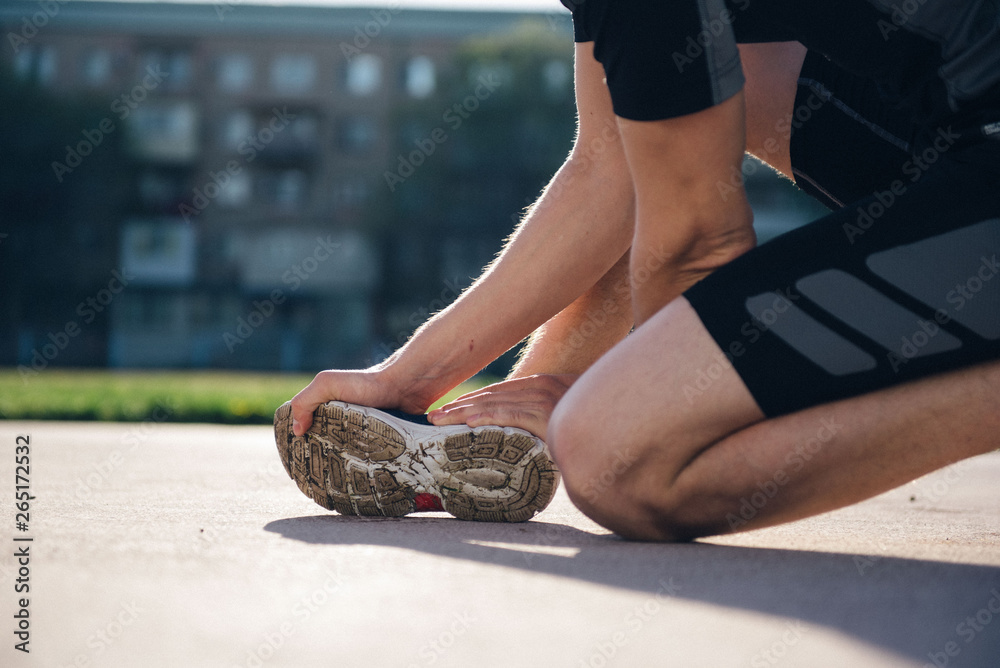 pain in the leg while running in the stadium. Trauma of the leg while ...