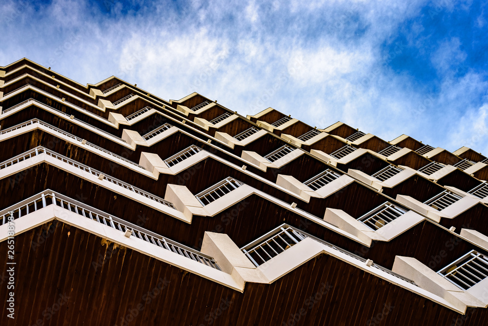 Residential building of symmetrical architectural patterns with blue ...