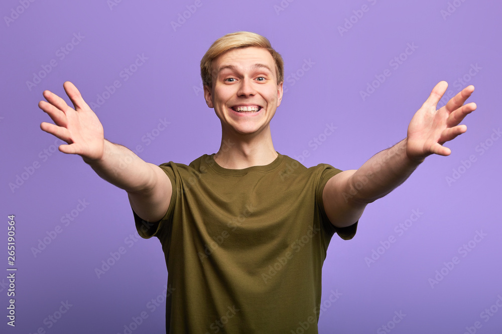positive happy handsome man welcoming people with his arms opened. I am ...