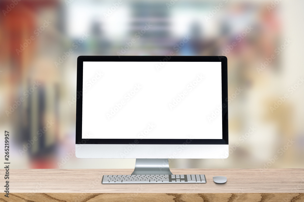 Blank screen desktop computer on plank wooden table top with blur ...