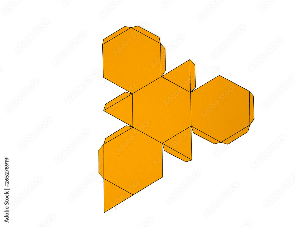 Geometric shape cut out of yellow paper and photographed from above on ...