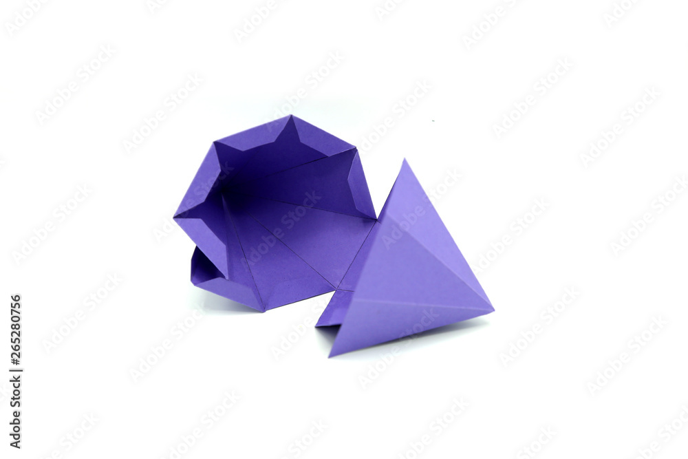 Geometric shape cut out of purple paper and photographed from above on ...