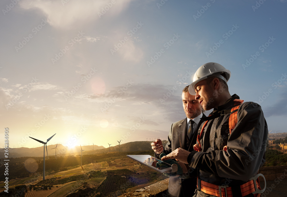 Windmill engineer and businessman planing new ecology project. they ...
