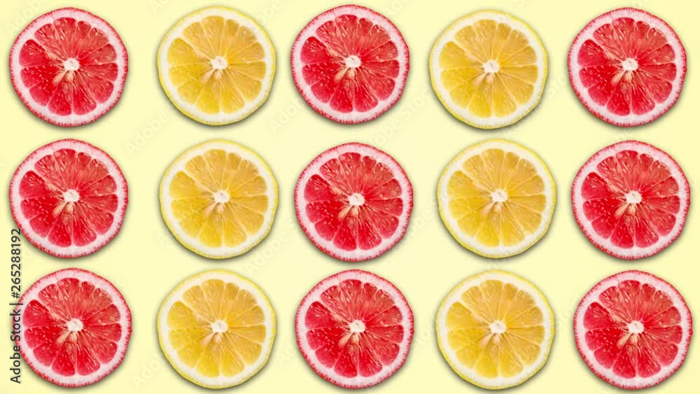 Abstract animation of sliced lemon and grapefruit on yellow pastel ...