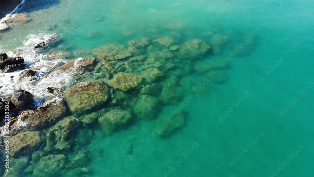 Reef from large stones seen through crystal sea waters, nice green ...