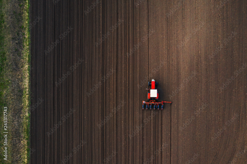 Top view of tractor planting corn seed in field Stock Photo | Adobe Stock