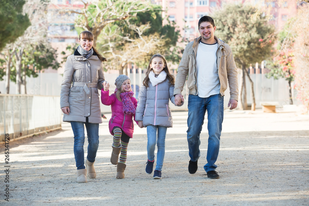 parents and little daughters taking a walk in park Stock Photo | Adobe ...