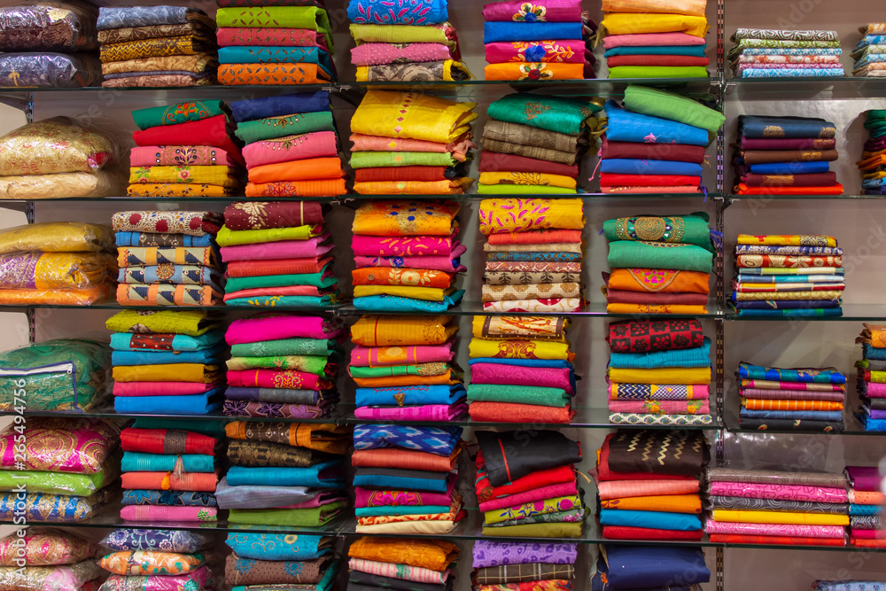 Beautiful Indian coloured cloth fabric folded on shelves for sale at ...