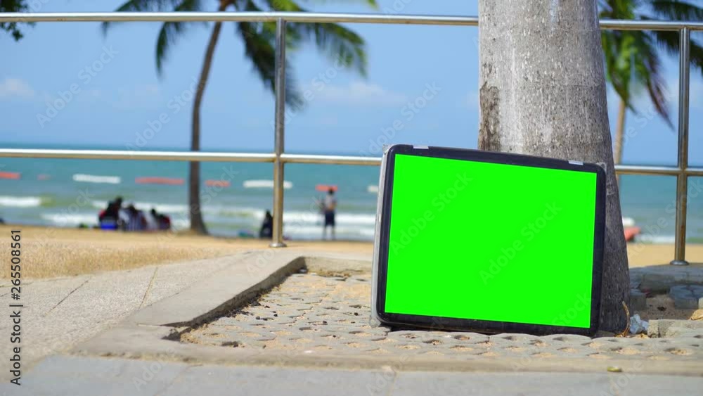 TV stands on the beach. Television with Green Screen. You can replace ...