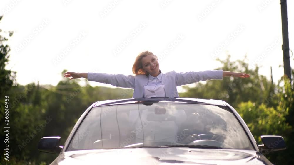 The girl leaned out into the hatch and rides along the road in a blue ...