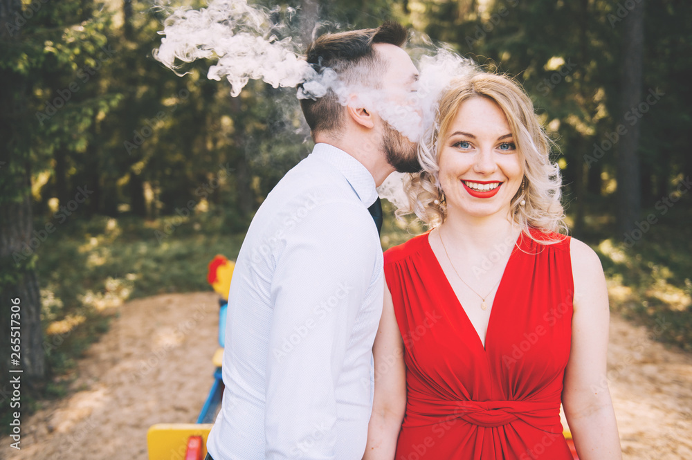 Smoking man in business clothes kissing young blonde girl with red lips ...