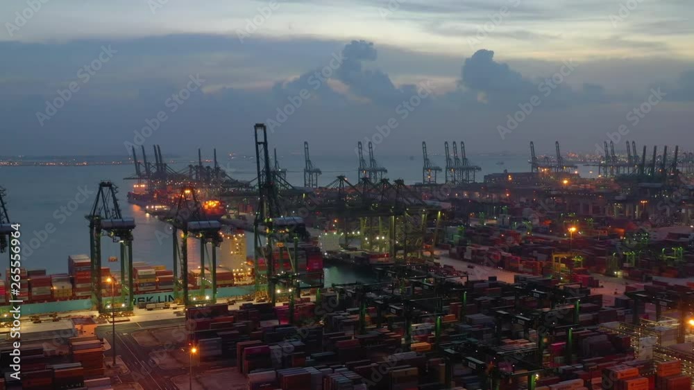 sunset illuminated singapore container port working terminal bay aerial ...