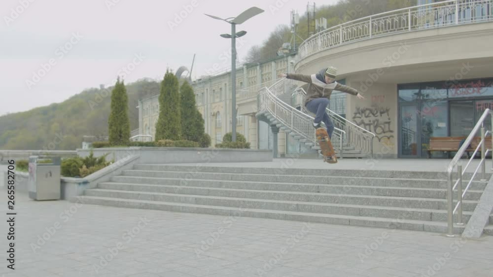 Young skater jumping over stairs performing good technique of ...