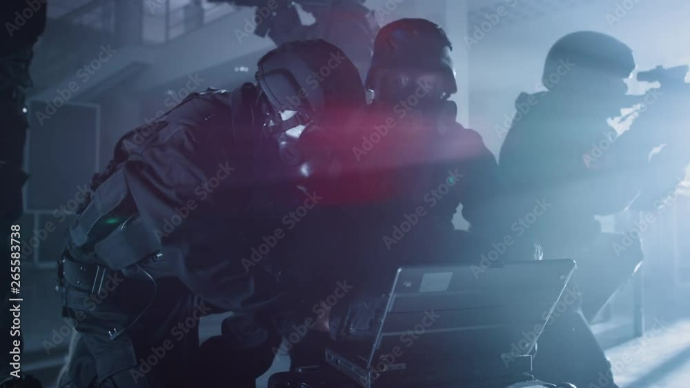 Masked Team of Armed SWAT Police Officers with Rifles are in Dark ...
