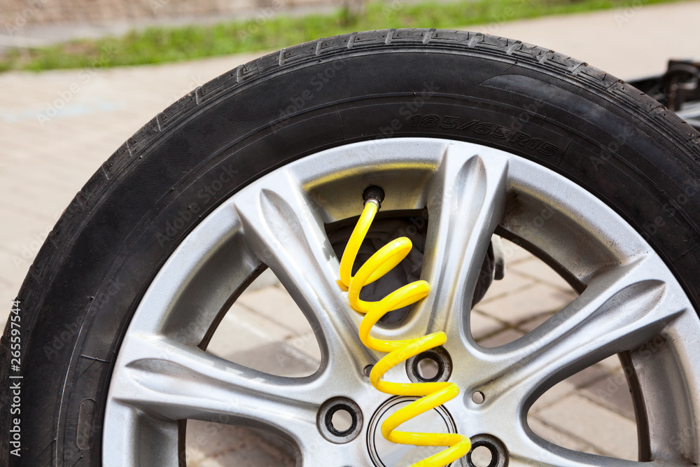 Yellow hose of tyre inflator connected to valve core, inflating ...